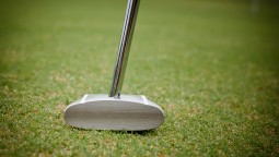 Golfers how to putt with the side saddle putting technique.